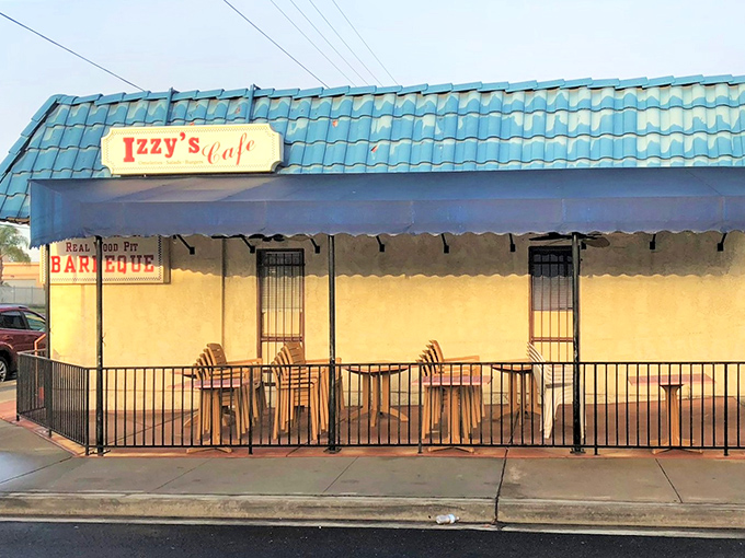 The iconic blue roof of Izzy's Cafe stands out like a beacon for hungry travelers in El Cajon. Comfort food paradise awaits behind that pink door!