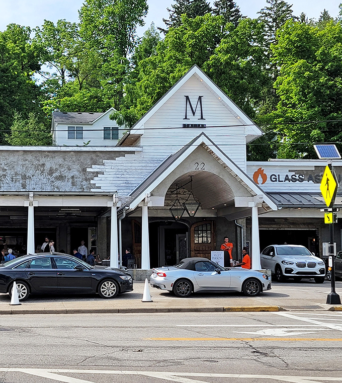 The distinctive white exterior of M Italian stands like a culinary beacon in Chagrin Falls, inviting hungry travelers with its charming farmhouse-inspired architecture and welcoming porch.