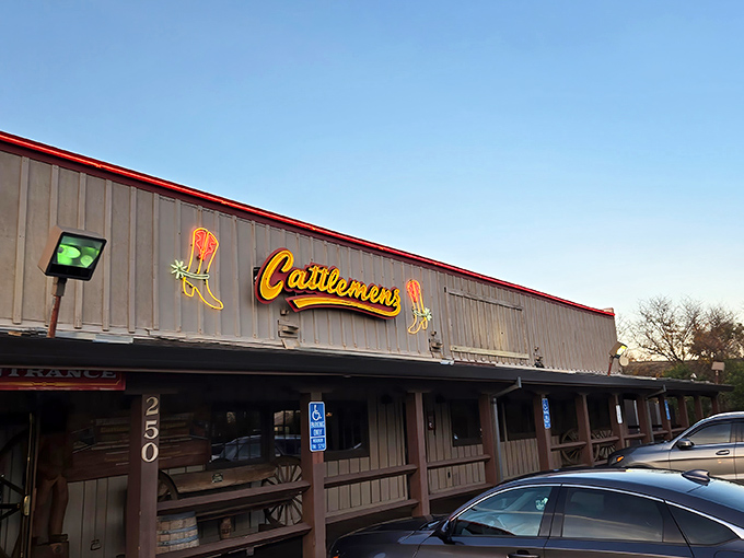 The iconic neon boot sign at Cattlemens beckons hungry travelers like a beacon of beefy salvation in Dixon's evening sky.