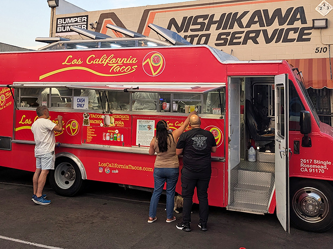 The bright red Los California Tacos truck stands out like a culinary beacon at Nishikawa Auto Service, drawing taco enthusiasts from across Pasadena.