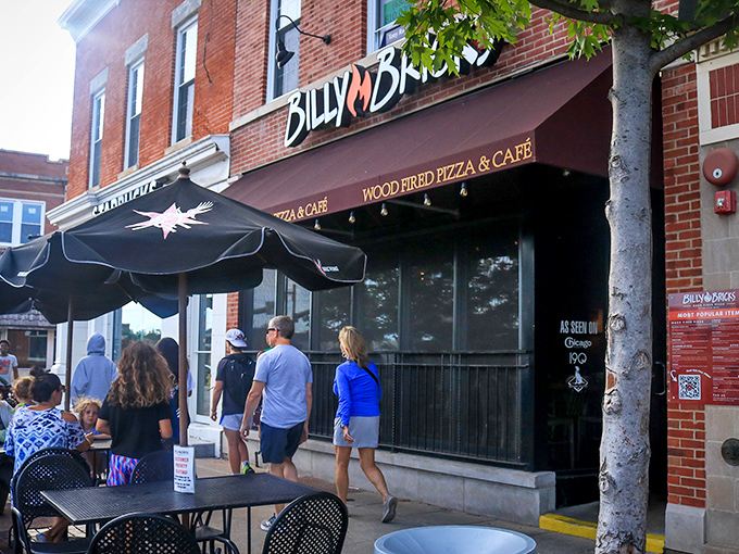 Downtown Wheaton's brick facade hides a pizza paradise where locals gather under black awnings for wood-fired bliss.