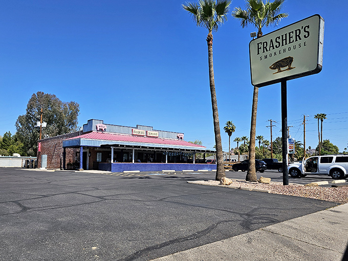 The unassuming exterior of Frasher's Smokehouse stands like a barbecue oasis in the Phoenix desert, palm trees standing guard over smoked meat paradise.