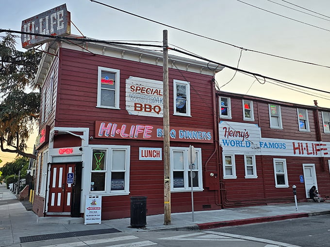 The crimson facade of Henry's Hi-Life stands like a time capsule in San Jose, its weathered sign promising BBQ treasures within.