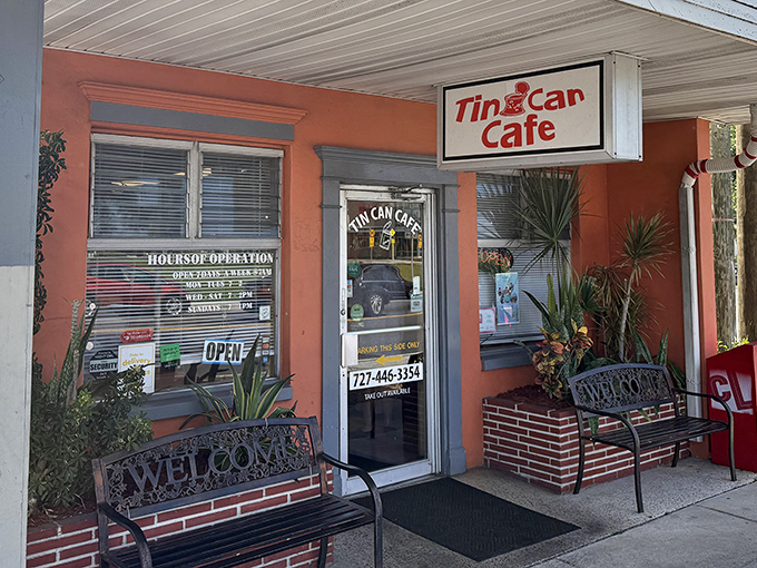The sunshine-yellow exterior of Tin Can Cafe stands out like a tropical bird in Clearwater, complete with those inviting benches that practically whisper, "Stay awhile."