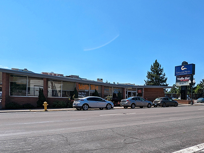 The unassuming brick exterior of Waffle Hut & Eatery proves once again that culinary treasures often hide in plain sight.