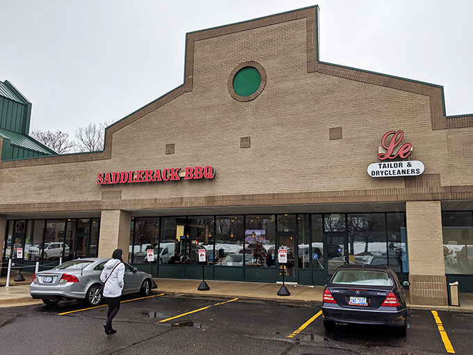 The brick facade and glowing red sign of Saddleback BBQ beckons like a lighthouse for the hungry and smoke-deprived souls of Okemos.