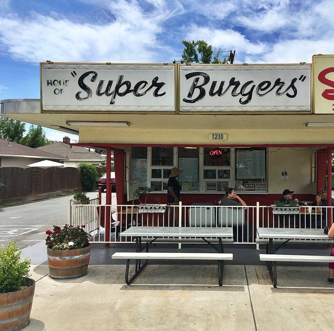 The iconic "Super Burgers" sign promises exactly what you'll get&mdash;a time capsule of American drive-in culture where simplicity reigns supreme.