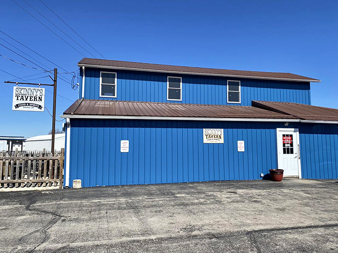 The blue building that launched a thousand cravings. Skinny's Tavern stands out against the Ohio sky like a beacon for burger enthusiasts seeking salvation from mediocre meals.