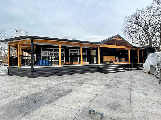 The modern rustic exterior of Magnolia & Pine beckons with its warm wooden accents and spacious porch&mdash;architectural proof that great food deserves a worthy stage.