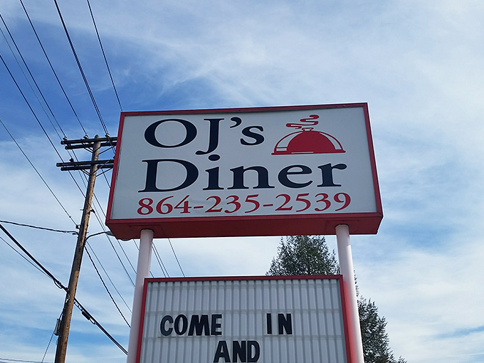 The iconic OJ's Diner sign beckons hungry travelers like a Southern lighthouse, promising comfort food salvation just beyond those doors.