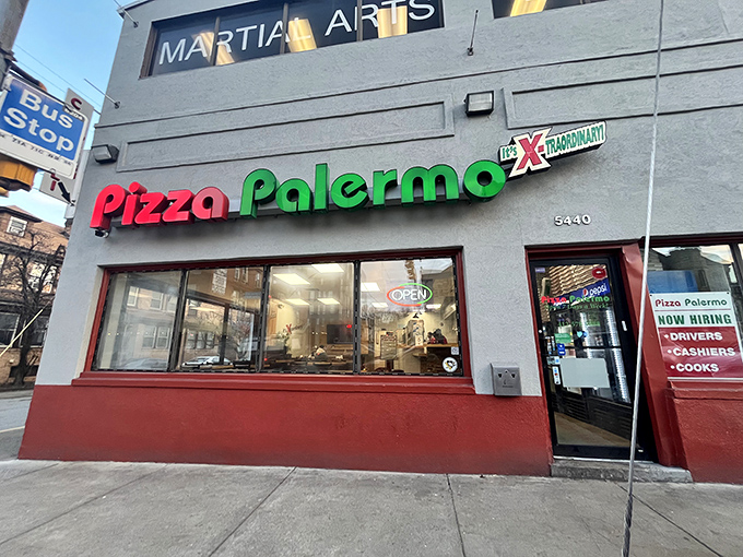 The unassuming storefront of Pizza Palermo, where culinary magic hides behind modest red and green signage. Pittsburgh's best-kept pizza secret sits quietly on Centre Avenue.