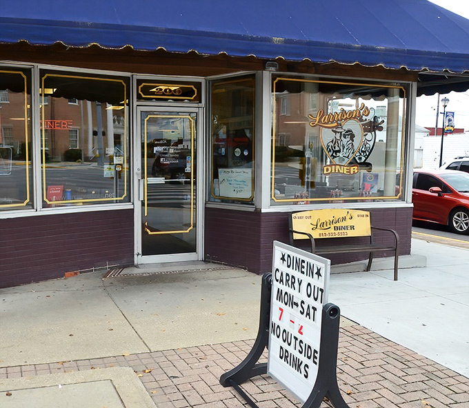 The purple storefront with its royal blue awning stands like a beacon of breakfast hope on Seymour's main drag. That yellow bench? Your waiting room to flavor town.