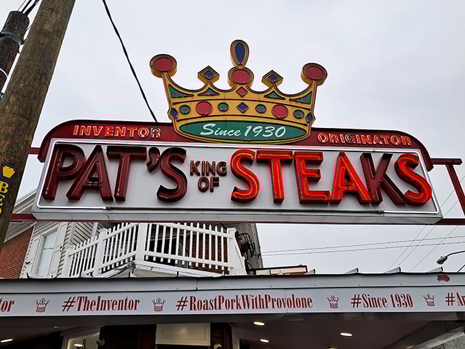 The crown jewel of Philly's sandwich scene beckons with neon promise. Pat's iconic sign has guided hungry pilgrims to cheesesteak nirvana since 1930.