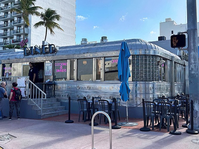 The gleaming silver exterior of 11th Street Diner shines like a beacon of nostalgia under Miami's blue skies, promising delicious time travel with every meal.