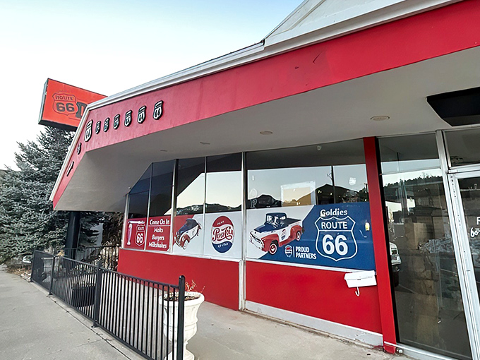 The vibrant red exterior of Goldies Route 66 Diner stands as a beacon to hungry travelers, promising a journey back to simpler times.