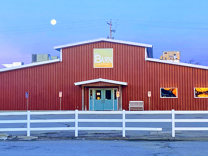 Bathed in twilight's glow with a full moon rising, The Barn transforms from restaurant to rural landmark as evening settles over Burrton.