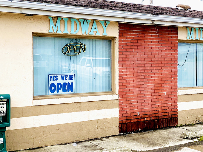 The turquoise "MIDWAY" sign has likely witnessed more small-town secrets than a church pew. This unassuming exterior promises authenticity without the fanfare.