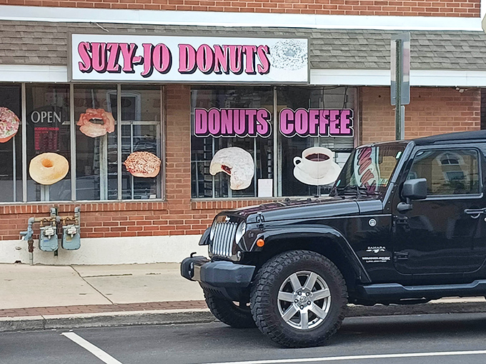 Morning sunshine illuminates the storefront where donut dreams come true. Even Jeeps park outside, knowing their rugged owners need the sweet balance of a perfect pastry.