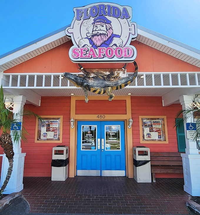 The coral-colored beacon of seafood salvation, complete with an alligator doorman who's clearly not getting paid enough for this gig.