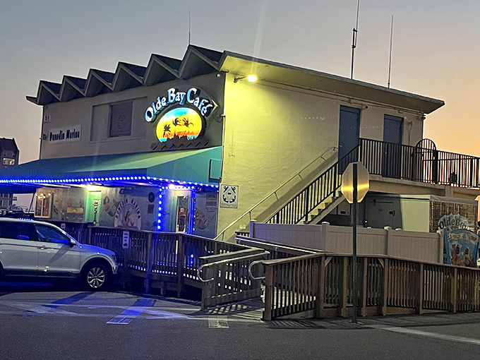 The neon-lit exterior of Olde Bay Caf&eacute; glows like a maritime lighthouse, beckoning hungry sailors and landlubbers alike to Dunedin's waterfront treasure.