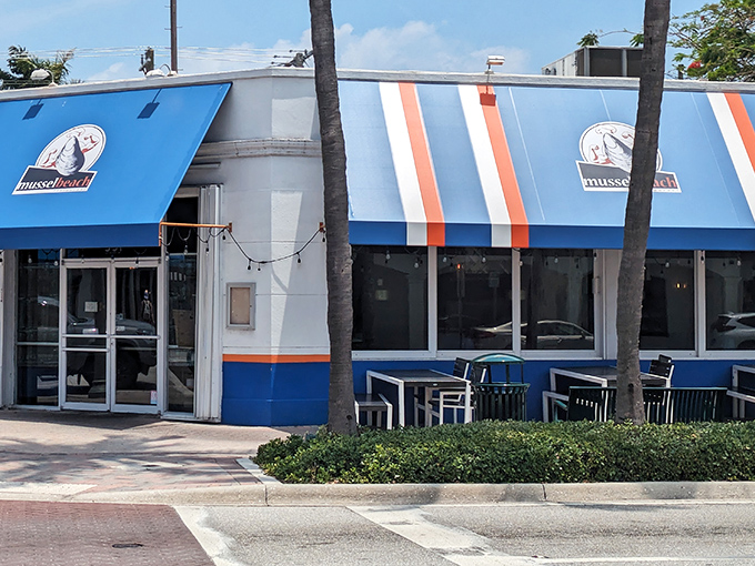 The iconic blue-and-white striped awning of Mussel Beach stands out on Atlantic Avenue like a maritime flag signaling "delicious seafood ahead!"