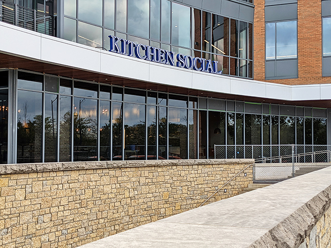 Kitchen Social's sleek exterior promises culinary adventures within. The modern brick and glass fa&ccedil;ade in Dublin's Bridge Park is like a well-dressed friend who always knows the best spots.