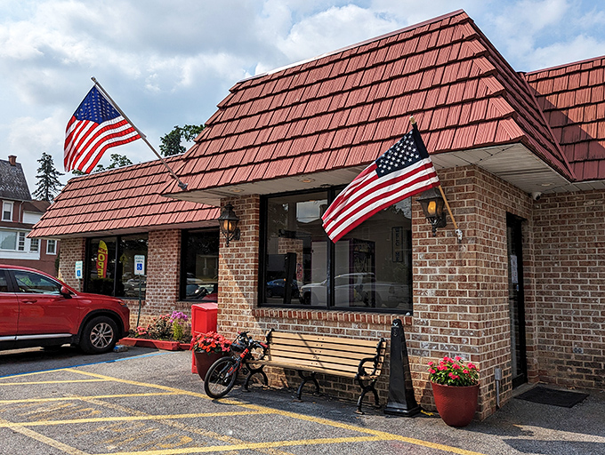 The iconic red-shingled roof and American flags announce you've arrived at breakfast paradise. Small-town charm with big-time flavor awaits.