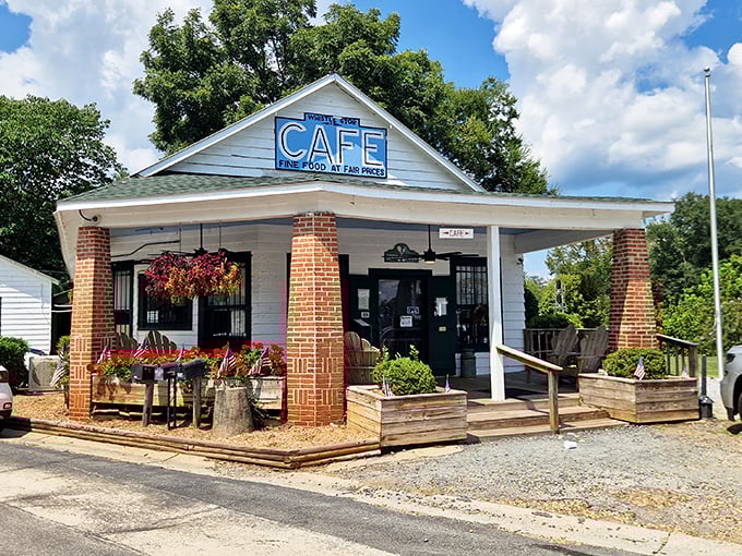 The quintessential Southern storefront that whispers, "Slow down, honey." White clapboard, brick columns, and that iconic blue sign promising good food and fair prices.