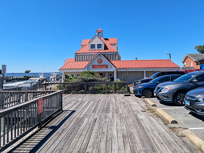 The iconic red-roofed Kentmorr Restaurant stands like a maritime lighthouse for hungry travelers, promising seafood treasures within sight of the very waters that supplied them.