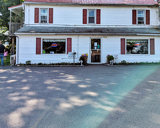 The charming white farmhouse exterior of Coventry Parlor beckons like an old friend with a delicious secret.