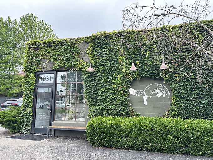 Mother Nature meets industrial chic. The cafe's iconic fox logo peeks through a living wall of ivy, like a woodland creature in its natural habitat.