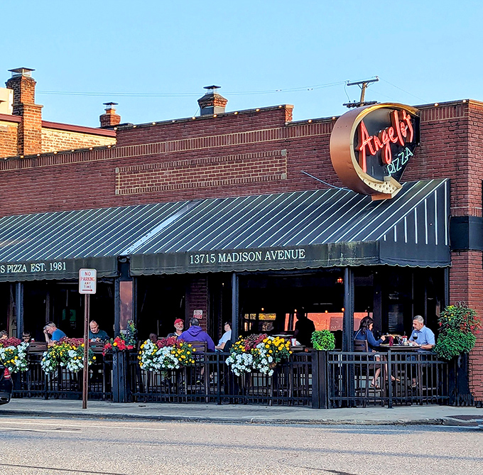 The iconic Angelo's Pizza storefront on Madison Avenue beckons with its vintage neon sign and flower-adorned patio&mdash;a Cleveland culinary landmark worth the pilgrimage.