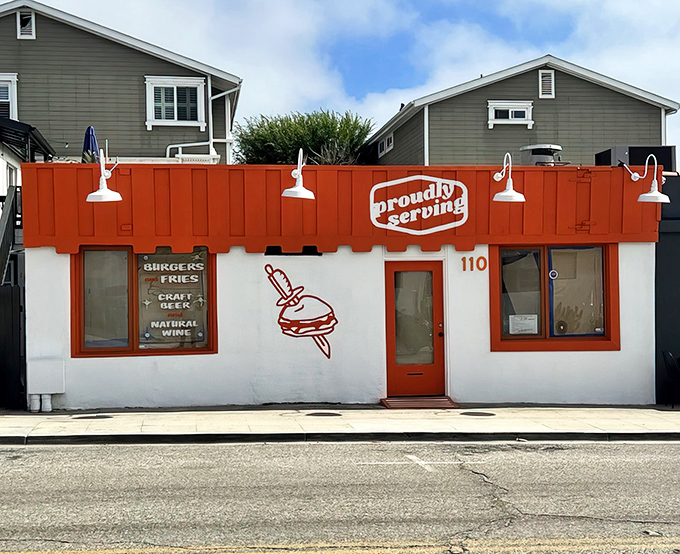 The unmistakable orange facade of Proudly Serving stands out in Hermosa Beach like a delicious beacon calling all burger enthusiasts home.