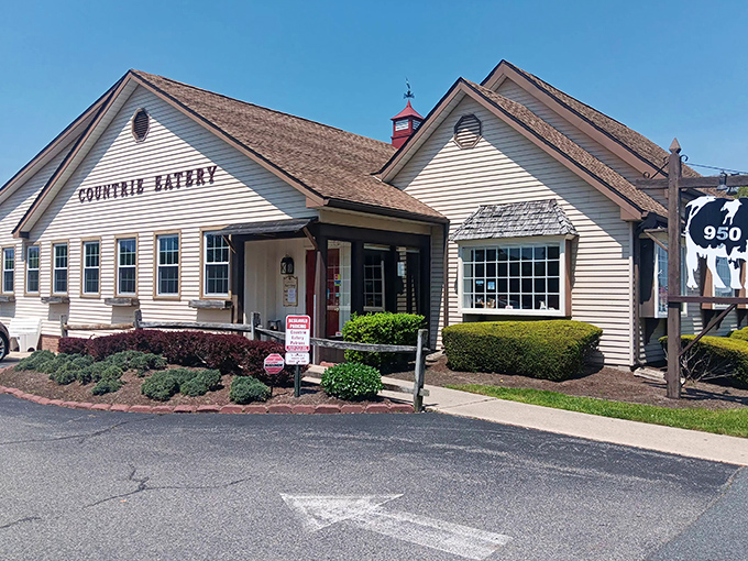 That classic "COUNTRIE EATERY" sign might as well read "Abandon diet, all ye who enter here." The red flowers add a touch of welcome.