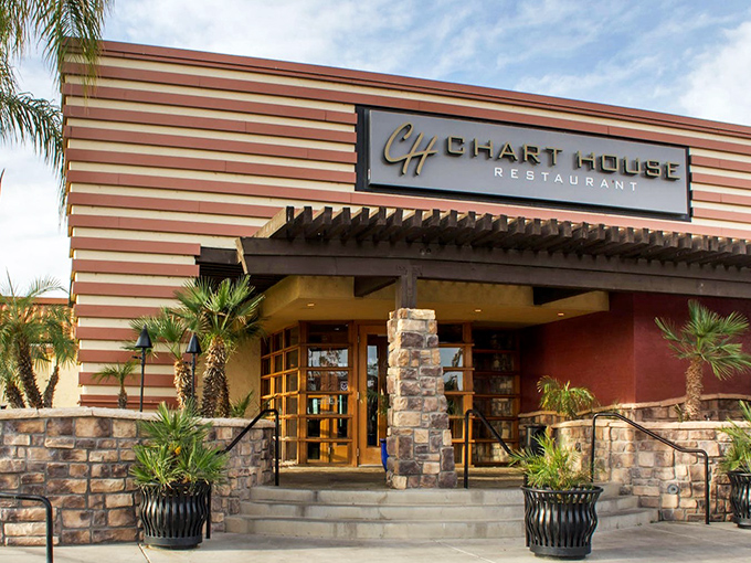 The Chart House exterior beckons with its distinctive striped facade and stone accents, like a culinary lighthouse guiding hungry travelers to flavor paradise.