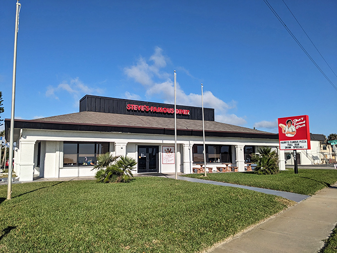 Steve's Famous Diner stands proudly against the Florida sky, its red sign promising "Happy Food, Good Vibes" &ndash; a roadside beacon for hungry travelers.