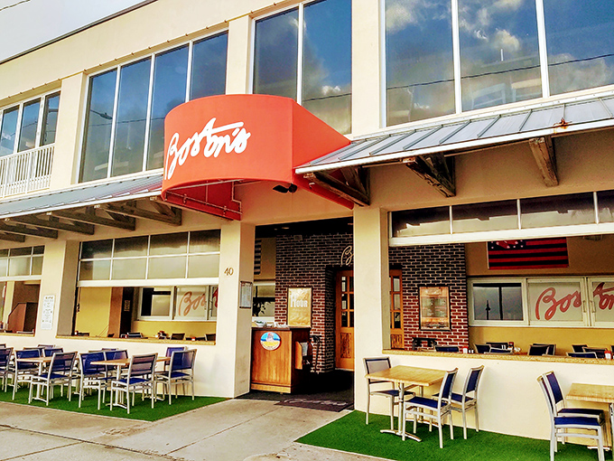 The iconic red awning of Boston's on the Beach beckons like a lighthouse for hungry souls, promising New England comfort in the heart of Delray.