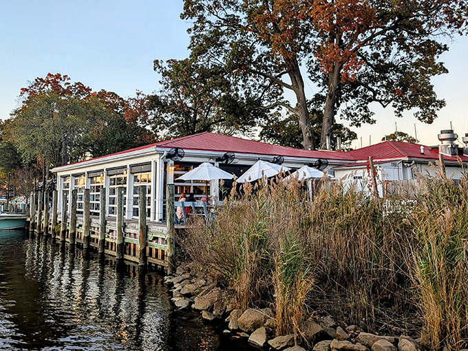 Waterfront perfection! The Point's red-roofed dining room hovers over Mill Creek like a seafood mirage, promising maritime delights with every gentle ripple.