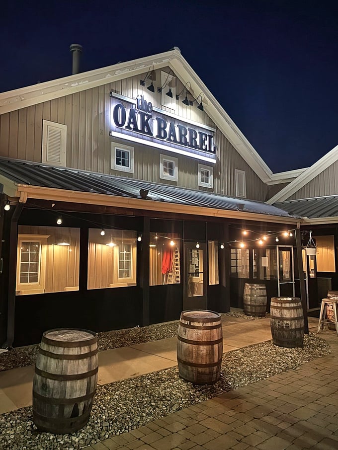The Oak Barrel glows like a beacon of culinary promise against the night sky, those wooden barrels standing guard like delicious sentinels.