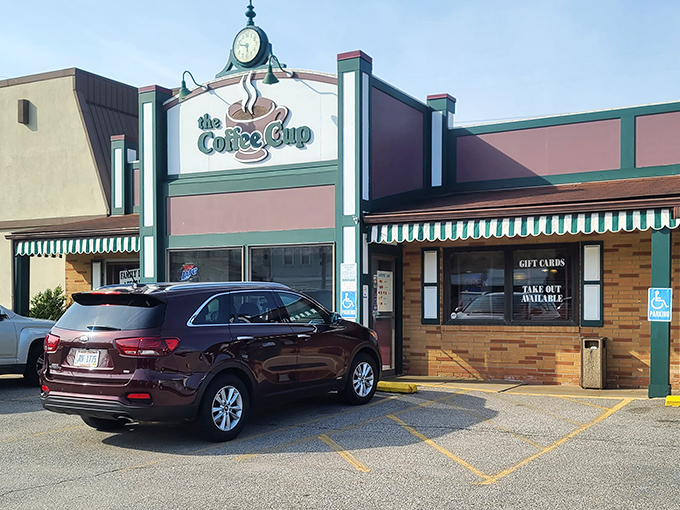The iconic green-striped awning of Coffee Cup Family Restaurant beckons like an old friend, promising comfort food that transcends its humble Bedford exterior.