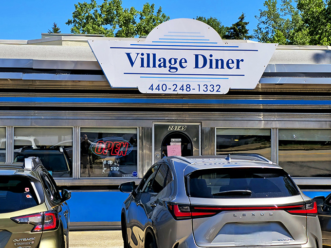 The classic silver exterior of Village Diner gleams in the sunshine, a time capsule of Americana promising comfort food that hugs your soul. 