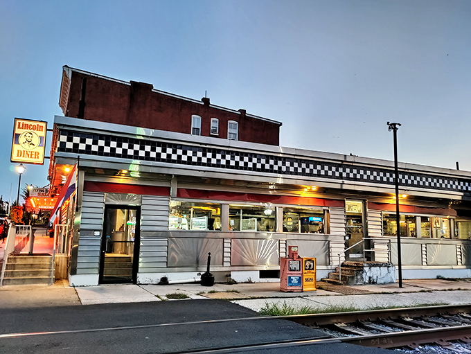 The iconic checkerboard trim and neon signage of Lincoln Diner glows like a beacon for hungry travelers in historic Gettysburg.