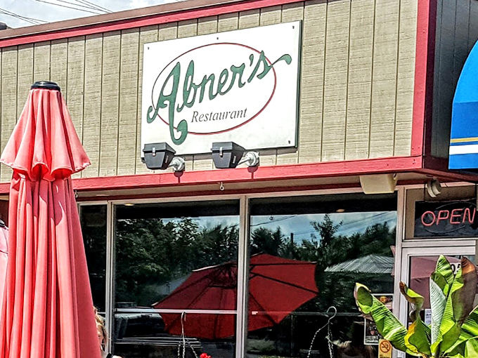 Abner's greets you with a bright red umbrella out front, adding a cheerful pop of color to its simple exterior. A small touch that says, 'come on in, we've been expecting you.