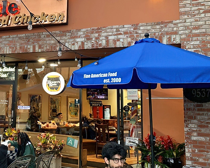 The blue umbrella beckons like a culinary lighthouse. Honey's Kettle's brick-faced exterior promises comfort food treasures within this Culver City gem.