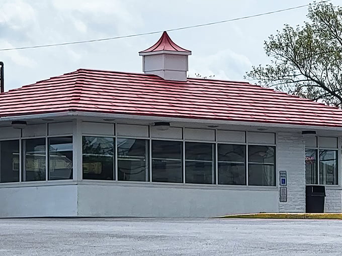 The iconic red-striped roof of Speck's stands as a beacon of hope for hungry travelers. No fancy architecture needed when the chicken's this good.