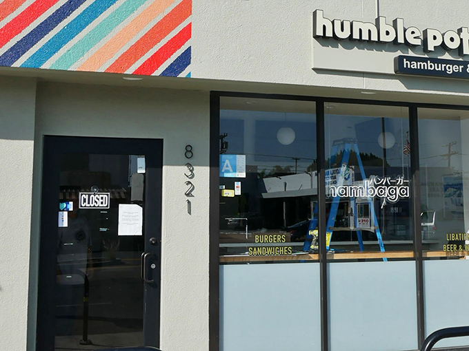 The colorful striped wall art welcomes you to Humble Potato, where culinary magic happens behind that unassuming "CLOSED" sign.