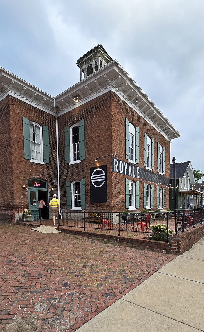 Historic brick meets burger brilliance at Royale With Cheese. The minimalist exterior with its inviting patio practically whispers, "Come in, we've got what you're craving."