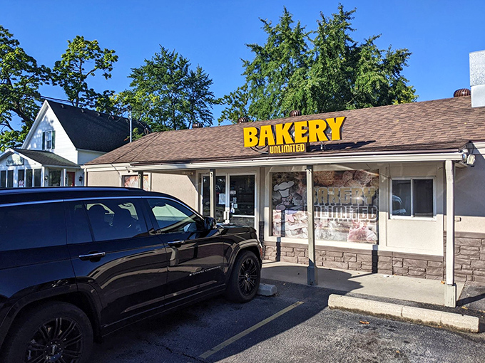 That bright yellow "BAKERY UNLIMITED" sign isn't just advertising &ndash; it's practically a beacon of hope for donut lovers everywhere.