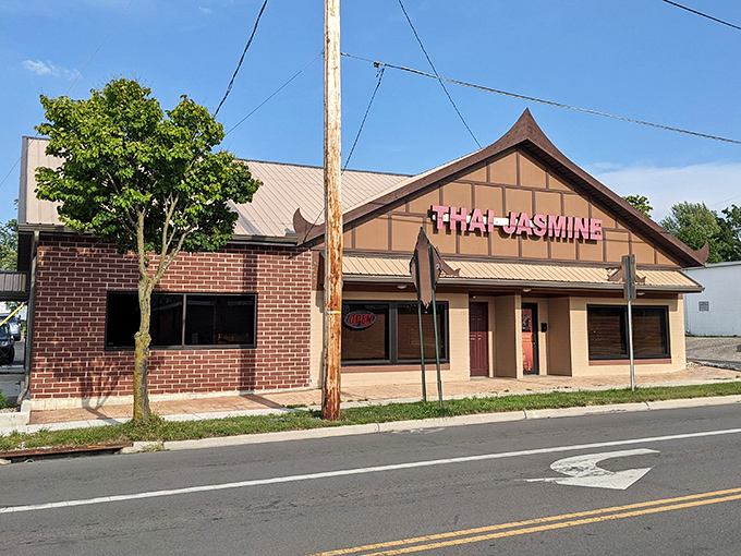 The unassuming exterior of Thai Jasmine might not stop traffic, but that pink sign promises culinary adventures that locals drive miles to experience.