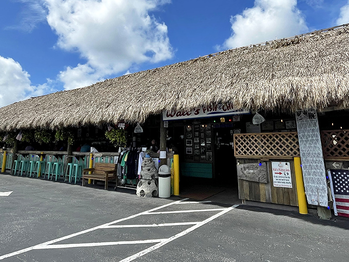 The thatched-roof entrance to Walt's promises tropical escape before you even step inside. Florida authenticity at its palm-frond finest.